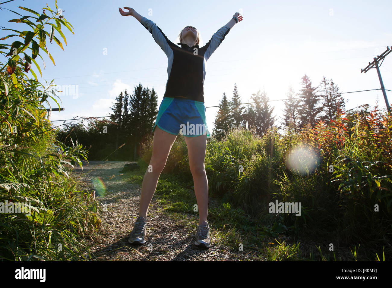 Woman stands outdoors stretching hi-res stock photography and images ...