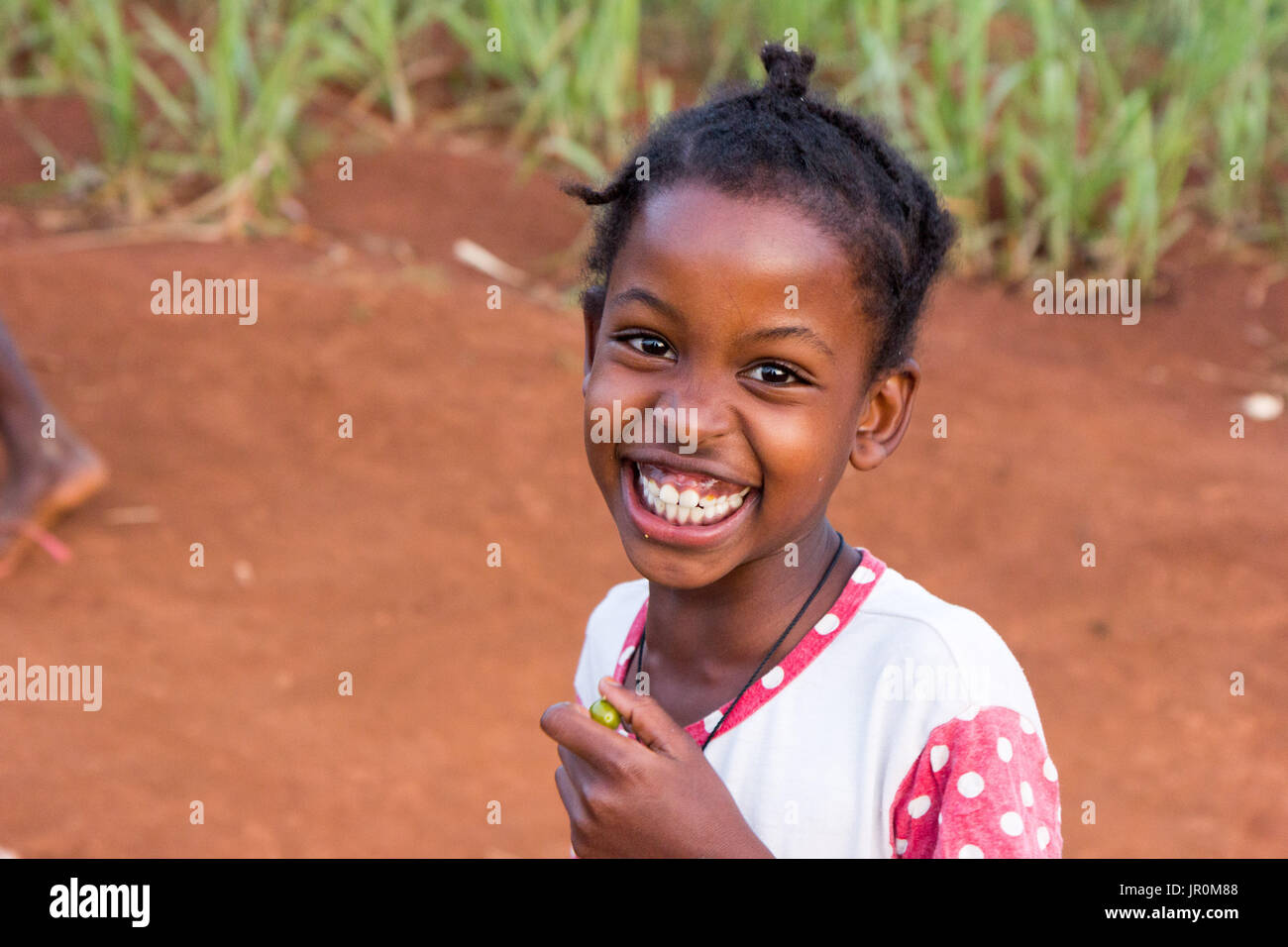 A happy laughing beautiful black little African girl Stock Photo - Alamy