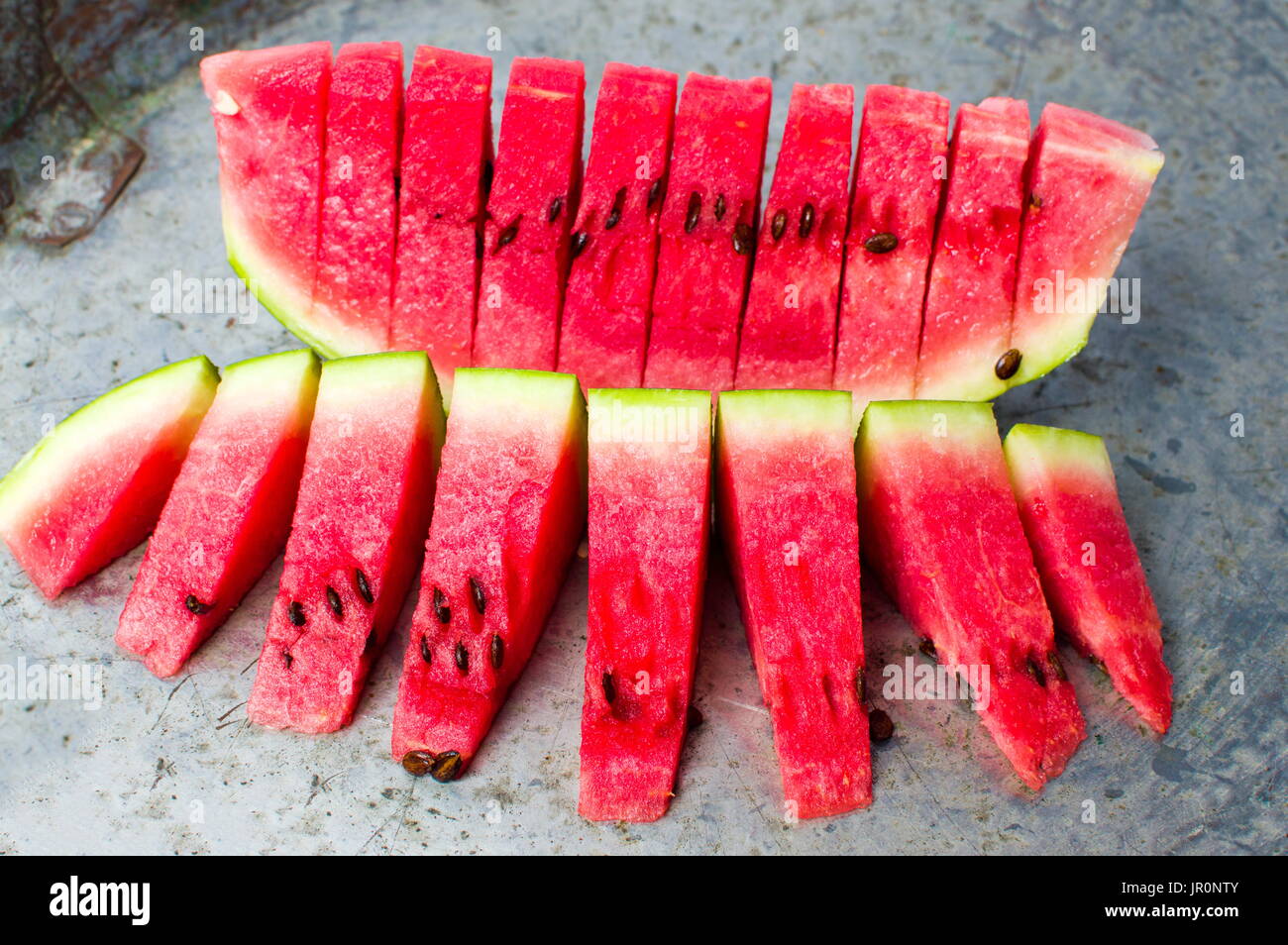 Watermelon fruit slices on the metal plate Stock Photo - Alamy
