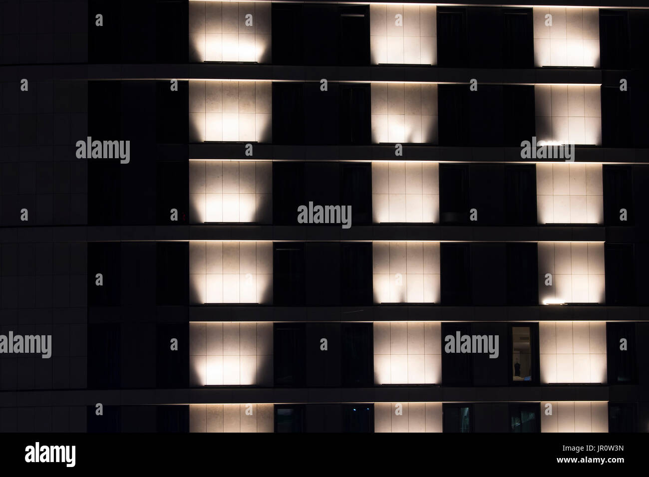 View of facade of a modern building at night Stock Photo - Alamy