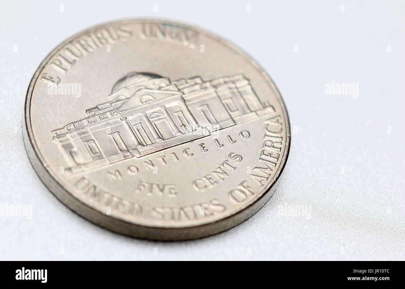 Nickel isolated on a silver background Stock Photo - Alamy