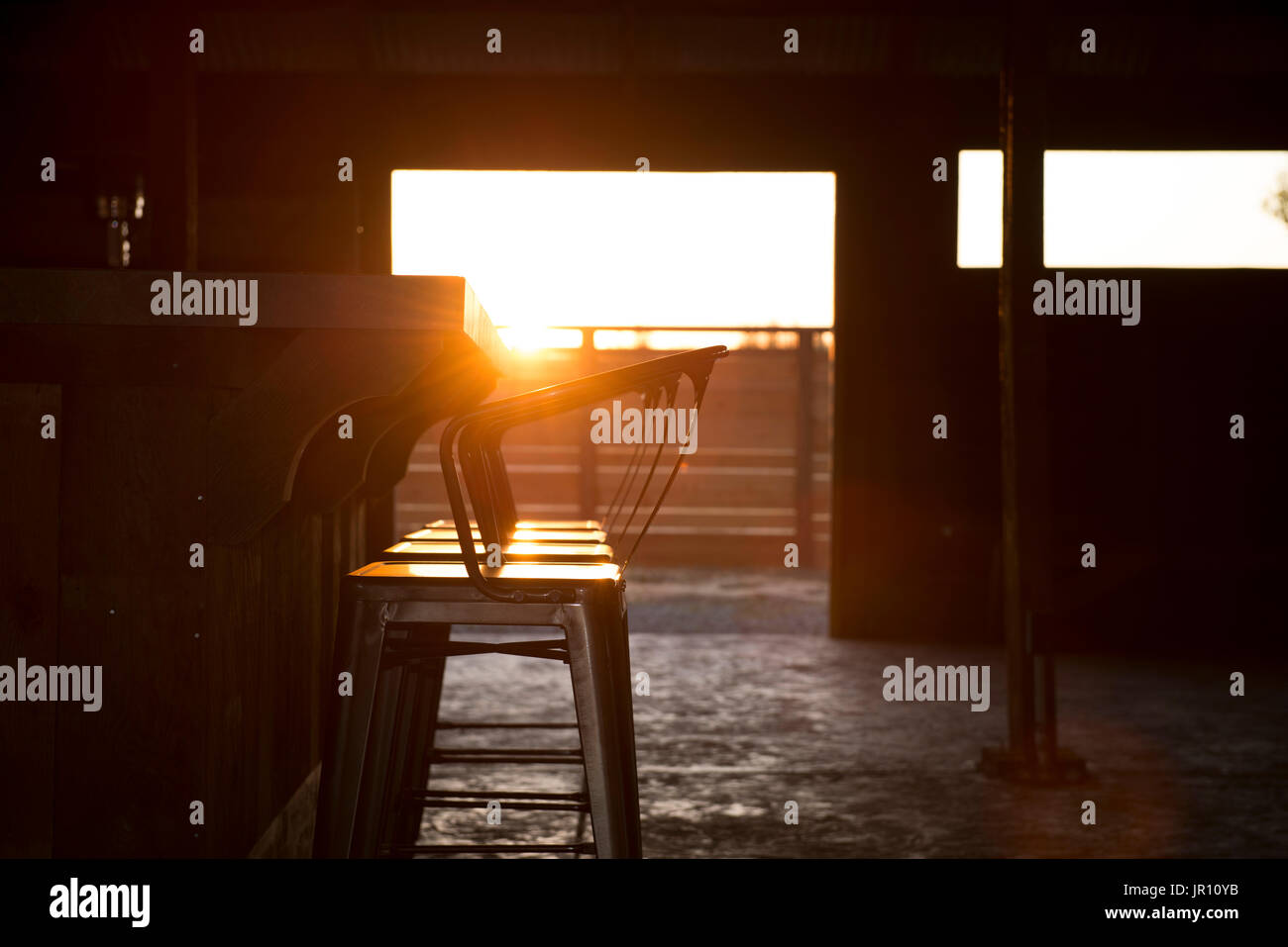 bar inside a barn, rustic bar, sun set Stock Photo - Alamy