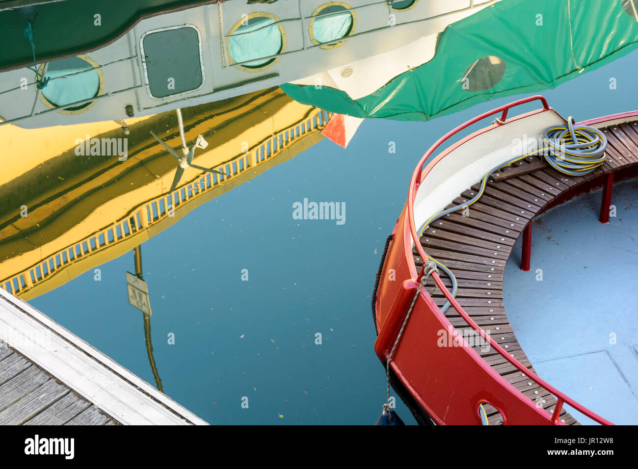 Graphic view of the rounded stern of a riverboat with the reflection of ...