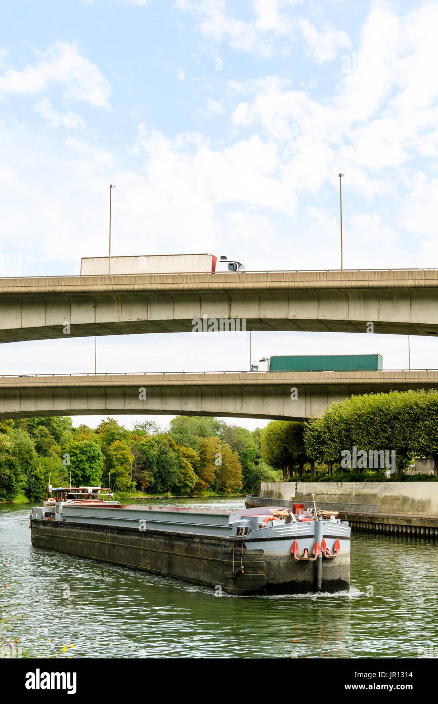 An empty cargo barge going down the river Marne toward Paris while semi ...