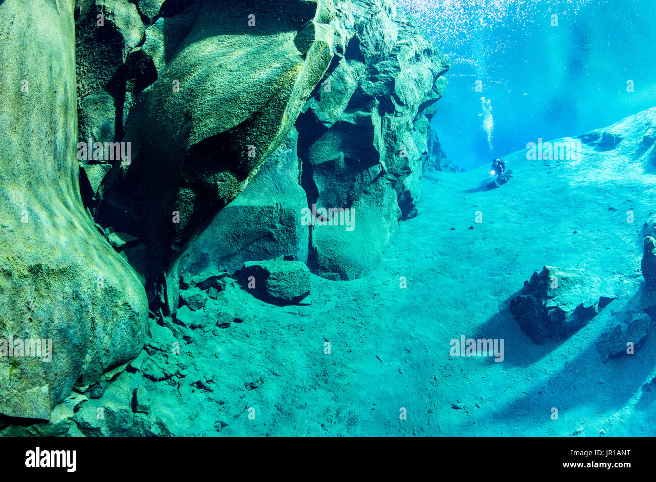Diver explores the cathedral at Silfra Canyon, deep fault filled with ...