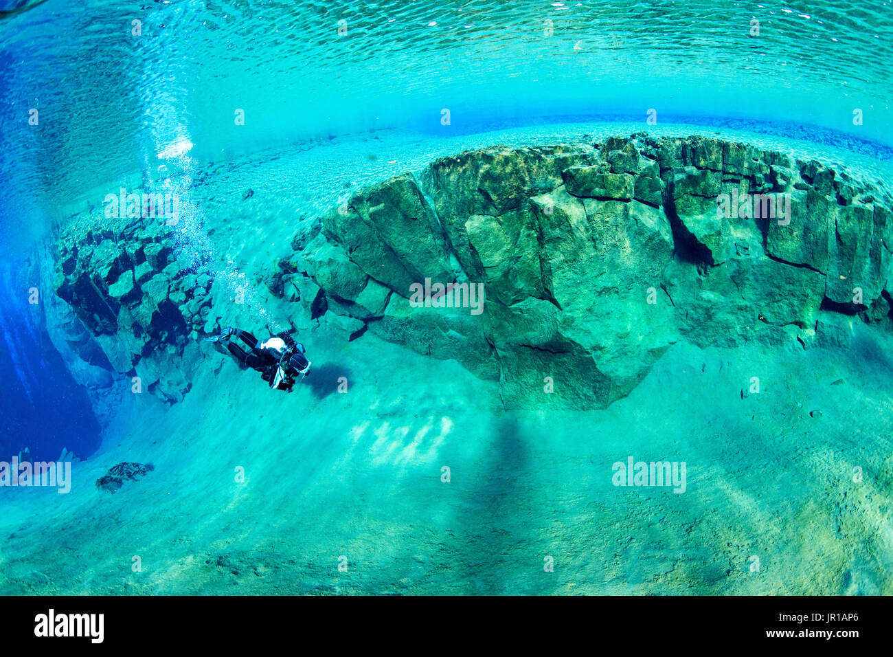 Diver exit the cathedral at Silfra Canyon, deep fault filled with fresh ...