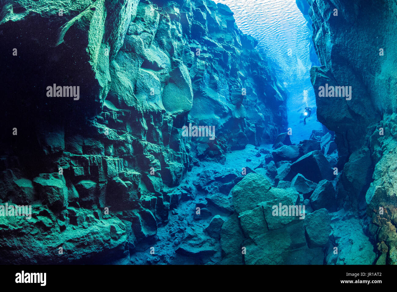 Diver explores the cathedral at Silfra fissure, deep fault filled with ...