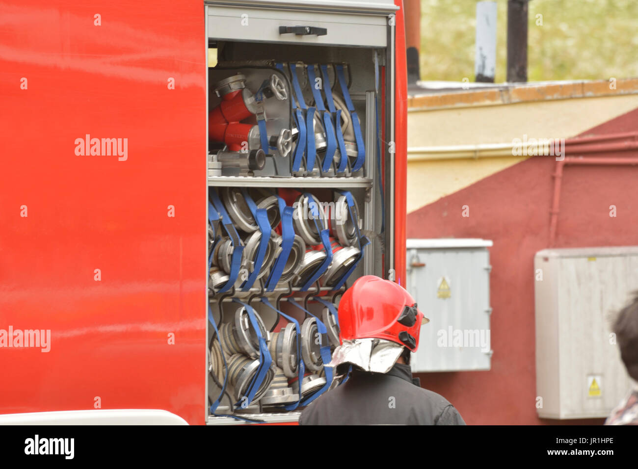 Fire truck with fire hoses in action Stock Photo - Alamy