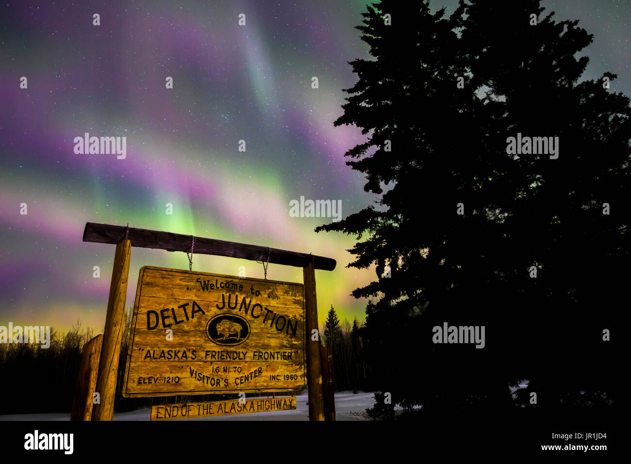 A Colorful Aurora Borealis Glows Behind The Delta Junction Welcome Sign ...