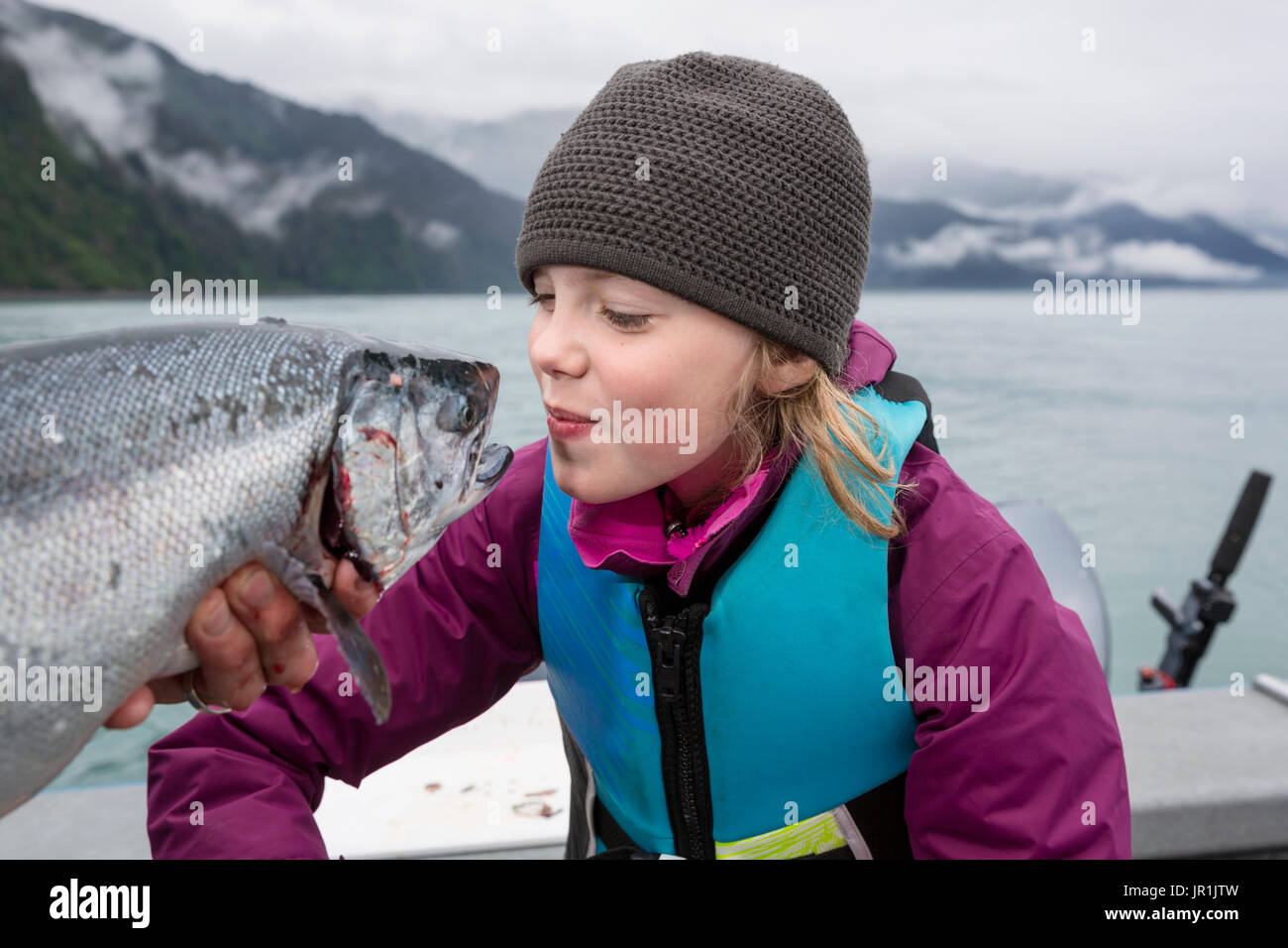 Young Girl Pretends To Kiss A Fish On The Lips, Seward, Southcentral ...