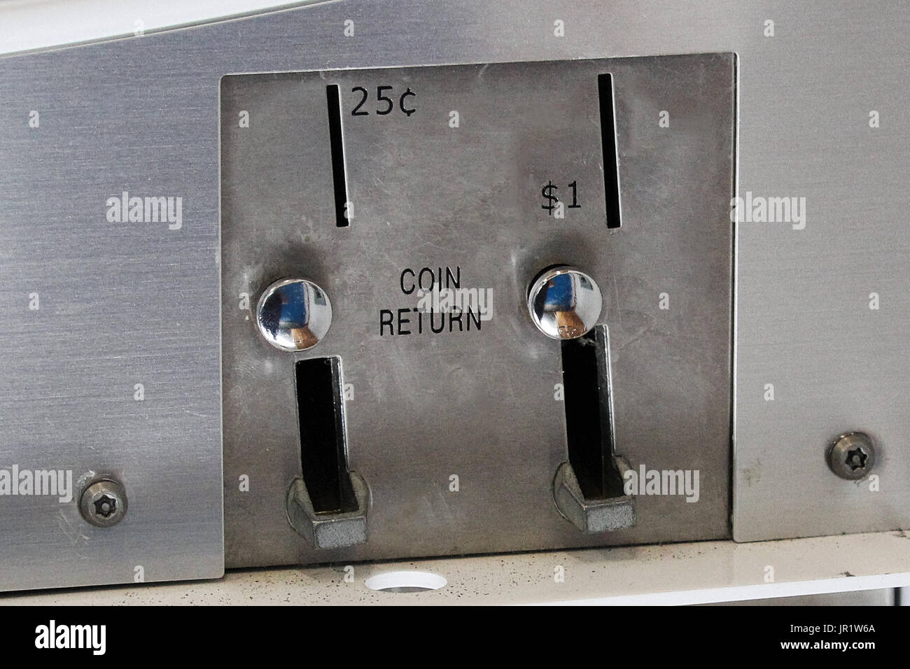 Closeup of a coin slot and return panel Stock Photo - Alamy