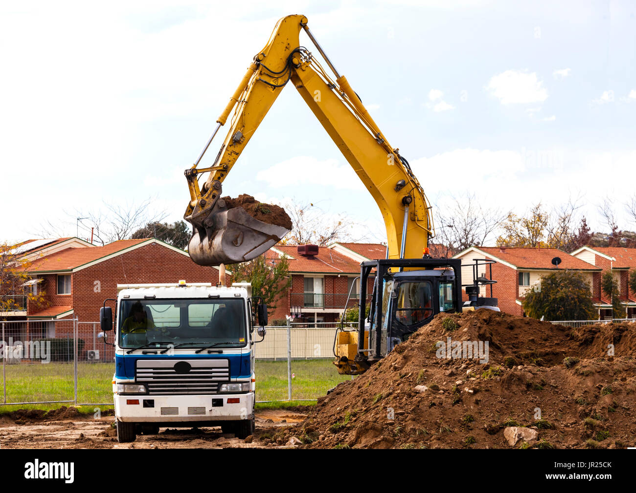 Loading soil for removal into tip truck Stock Photo - Alamy