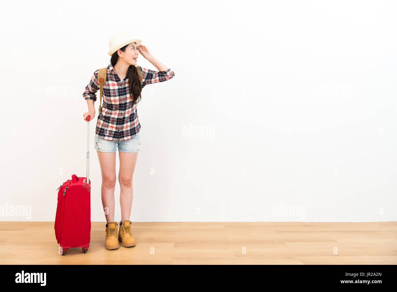 smiling pretty female backpacker carrying travel luggage suitcase ...