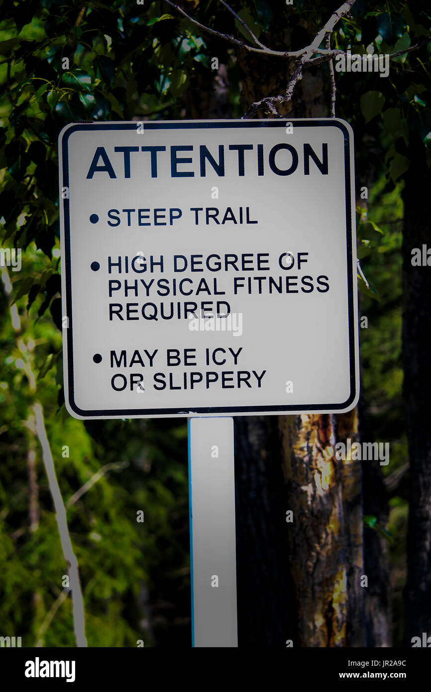 An attention steep trail sign with additional warnings Stock Photo - Alamy