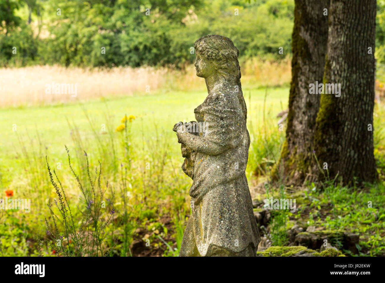 Ancient stone statue of a woman in an old garden Stock Photo - Alamy