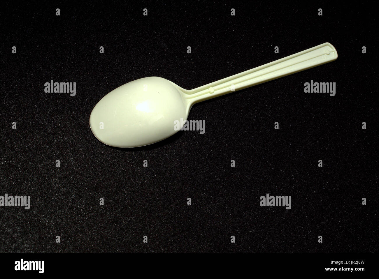 Close up still life of a simple plastic spoon. Part of a continuing ...