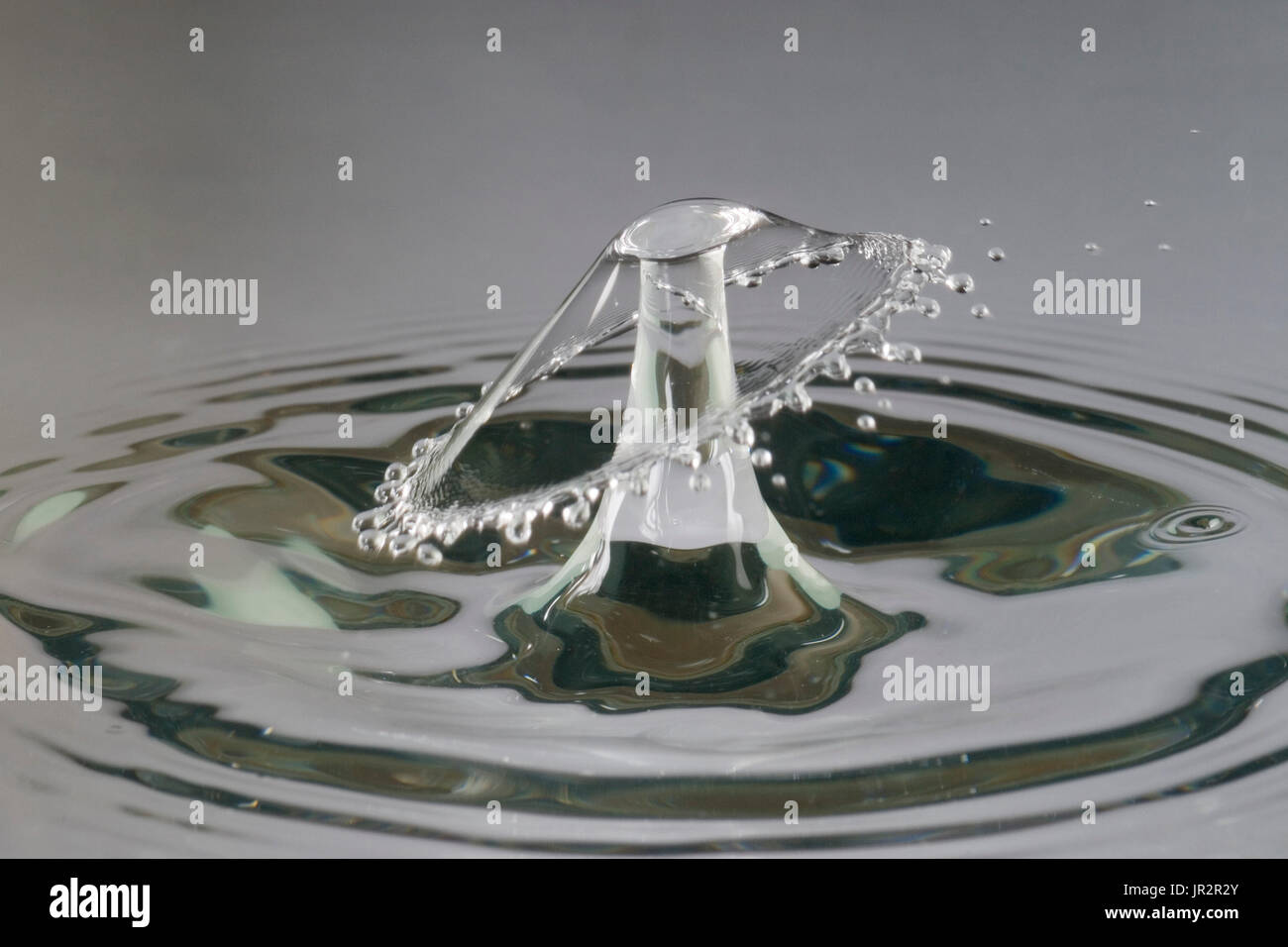 Single drop of water falling in water Stock Photo - Alamy