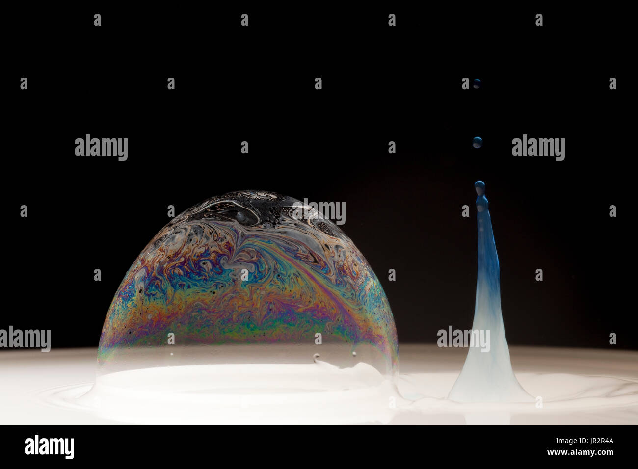 Colorful water drop and soap bubble on black background Stock Photo - Alamy
