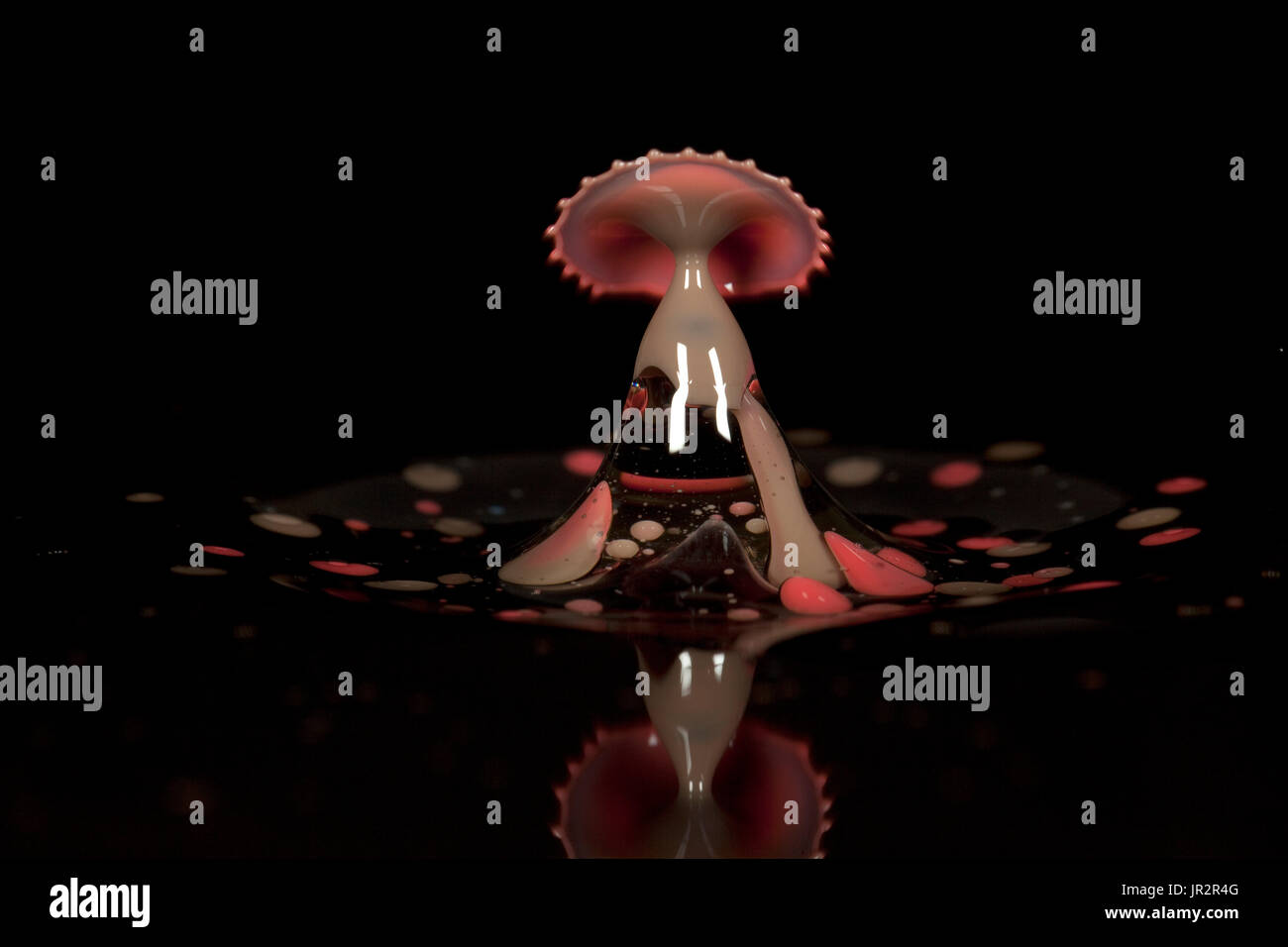 Colorful milk drop on black background Stock Photo - Alamy