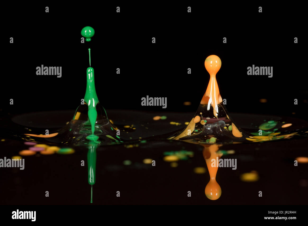 Colorful milk drops on black background Stock Photo - Alamy