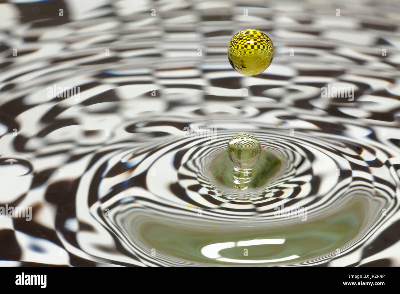 Colorful water drop on a grid background Stock Photo - Alamy