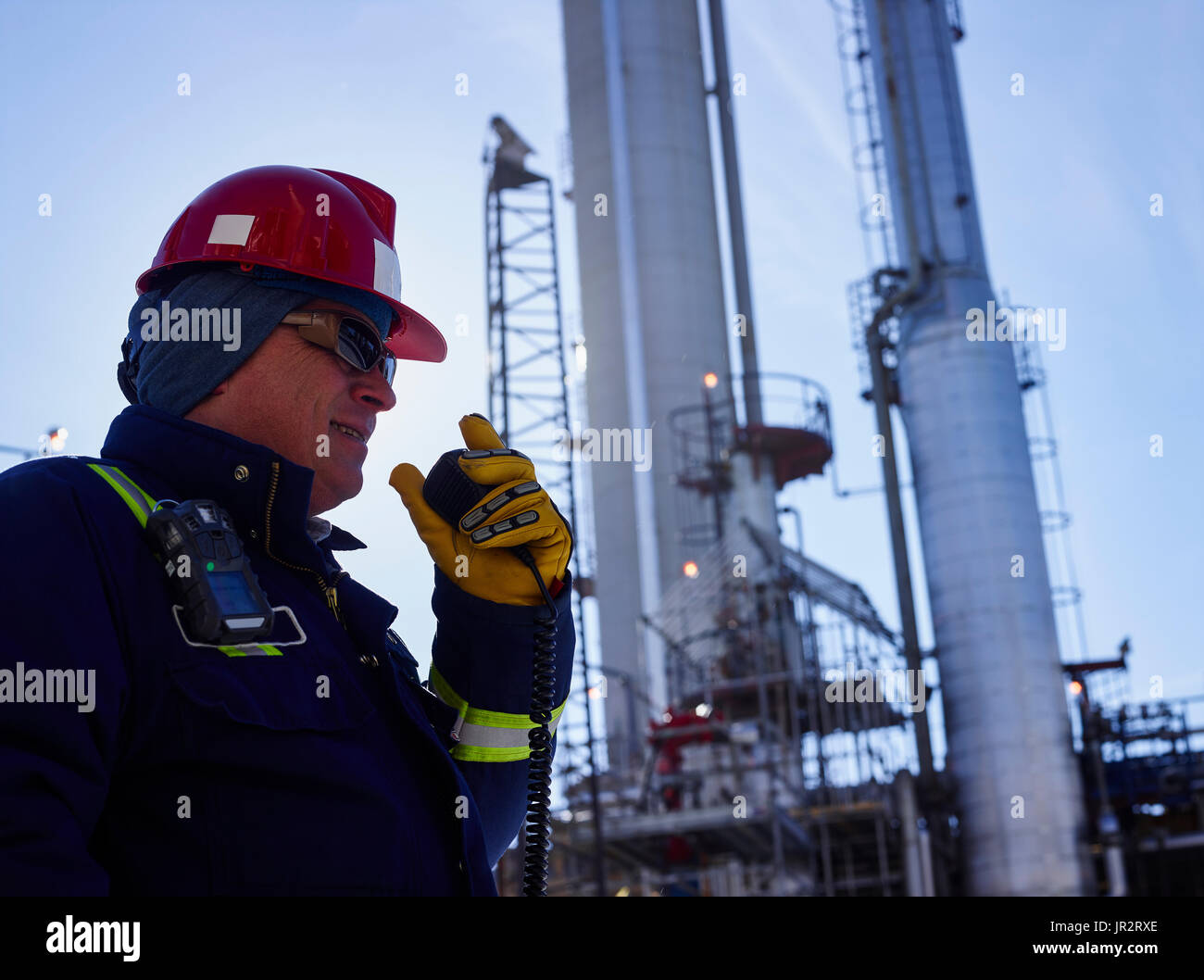 Tradesman Talking Into A Radio While Working At A Refinery; Edmonton ...