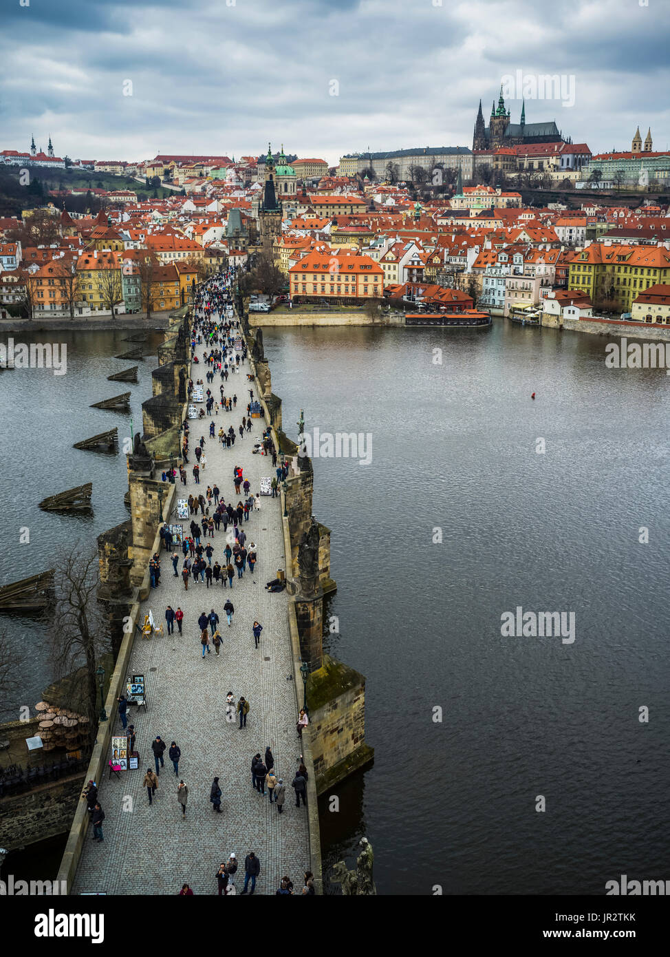 Pedestrians On Charles Bridge Over The Vltava River And Prague Castle In The Distance; Prague ...