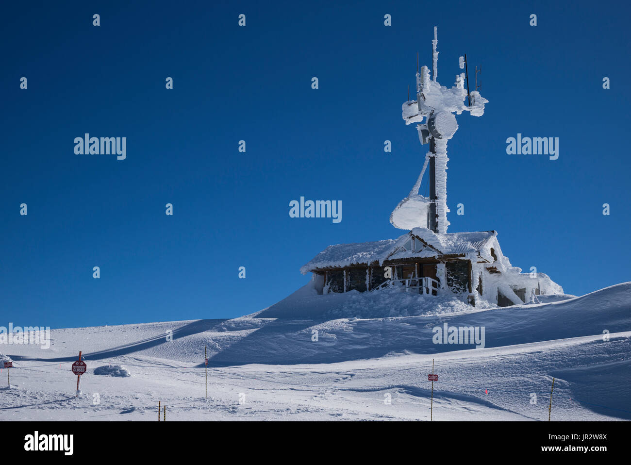 A Transmission Tower And Building Covered In Ice And Snow At A Ski ...