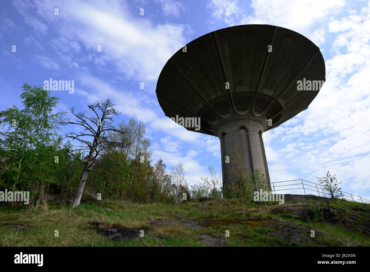 water tower on rock beside a dry tree Stock Photo - Alamy