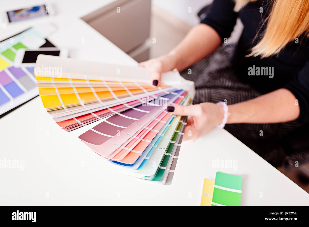 Woman designer or architect choosing color from color palette Stock ...