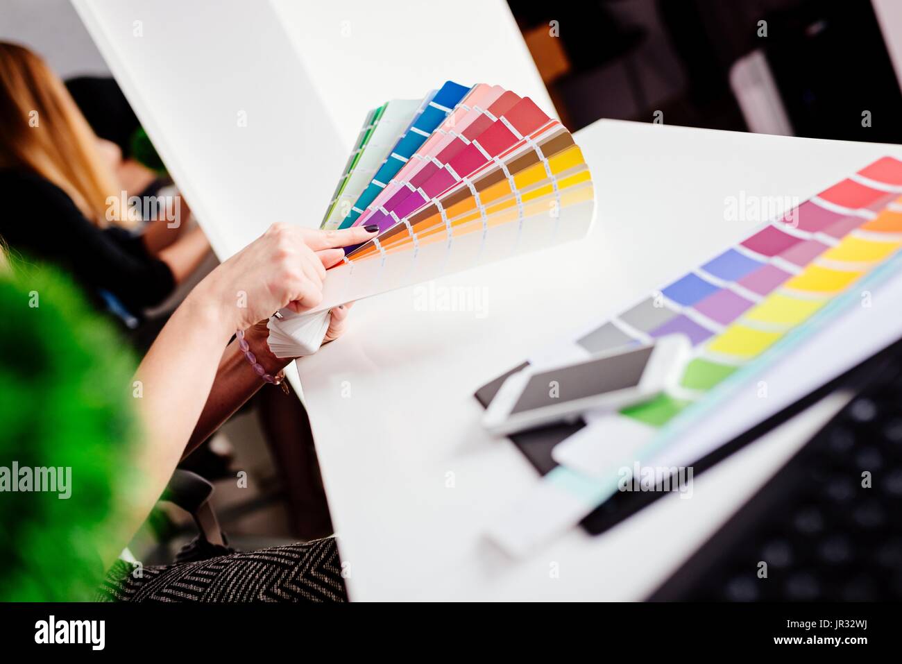 Woman designer or architect choosing color from color palette Stock ...