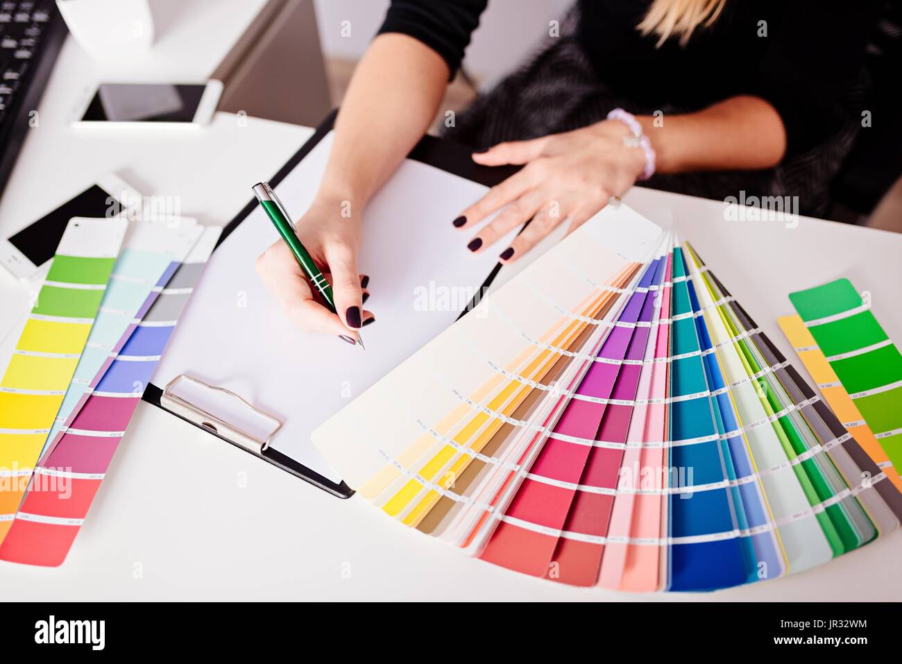 Woman designer or architect choosing color from color palette Stock ...