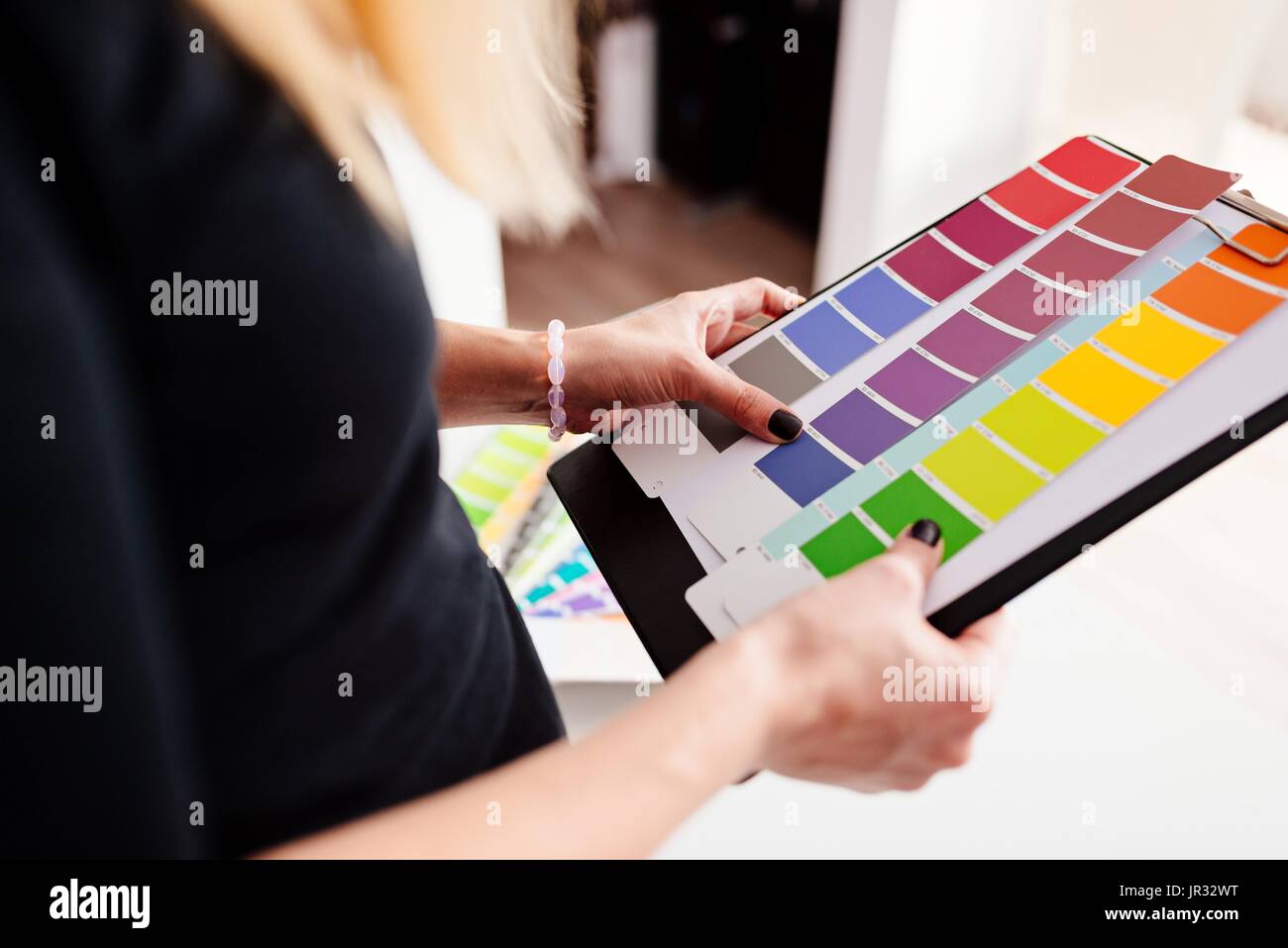 Woman designer or architect choosing color from color palette Stock ...