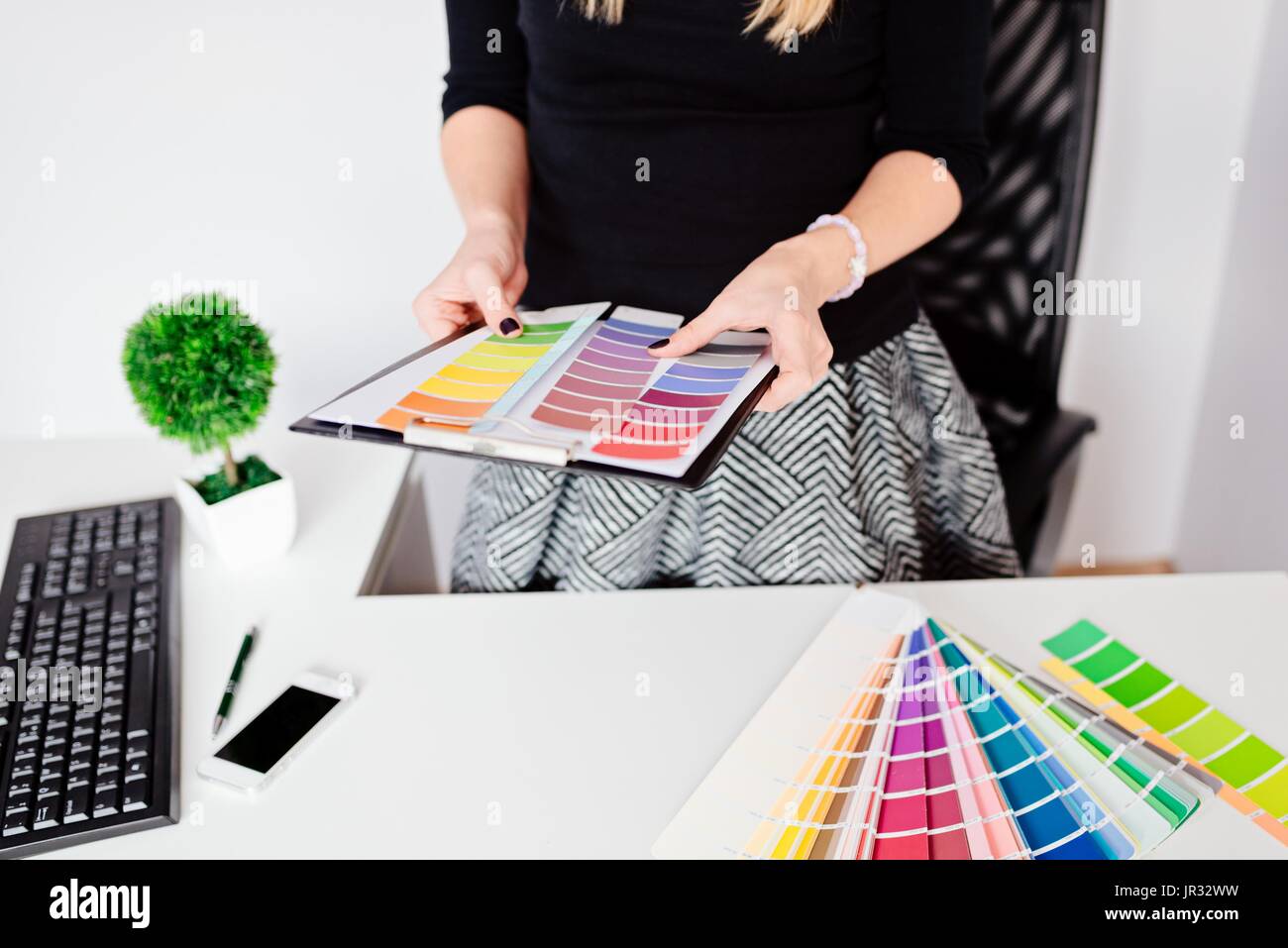 Woman designer or architect choosing color from color palette Stock ...