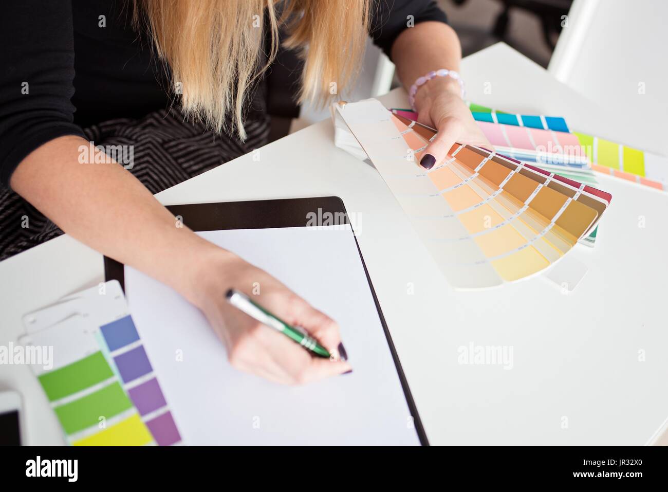 Woman designer or architect choosing color from color palette Stock ...