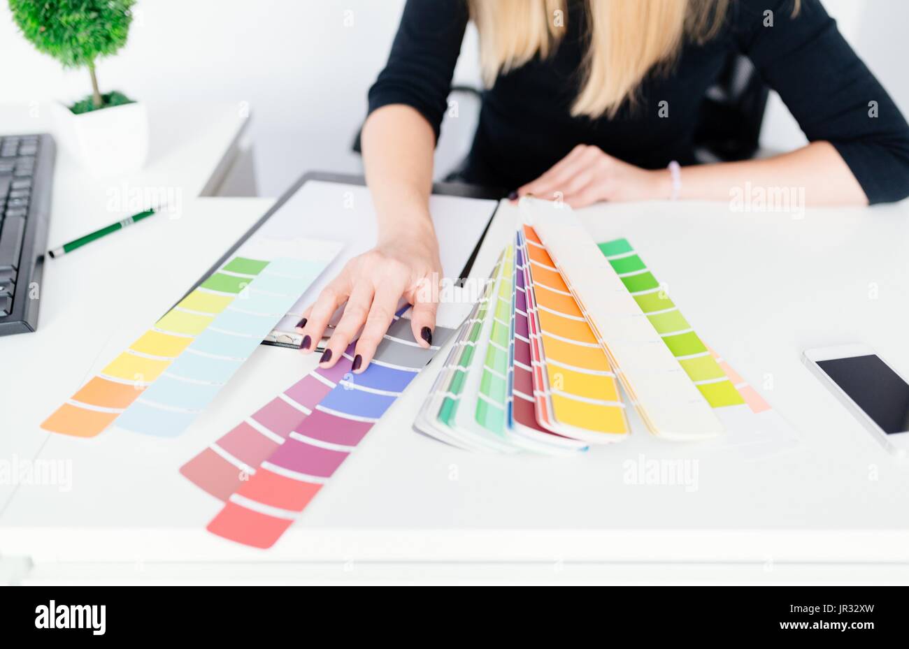 Woman designer or architect choosing color from color palette Stock ...