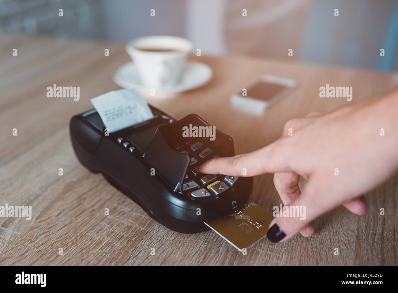 Consument entering pin code on card terminal during payment Stock Photo ...