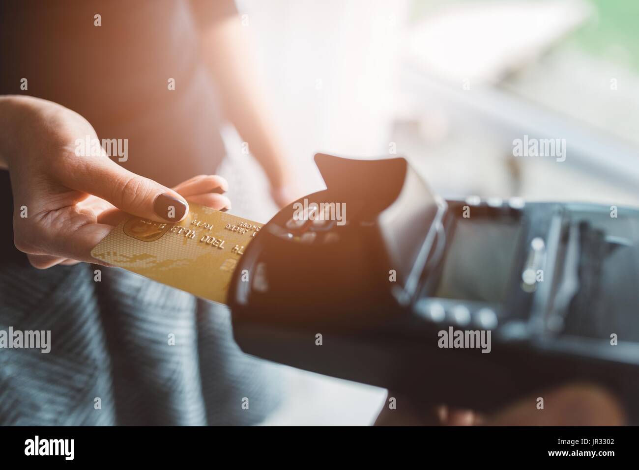 Woman pays plastic card hi-res stock photography and images - Alamy