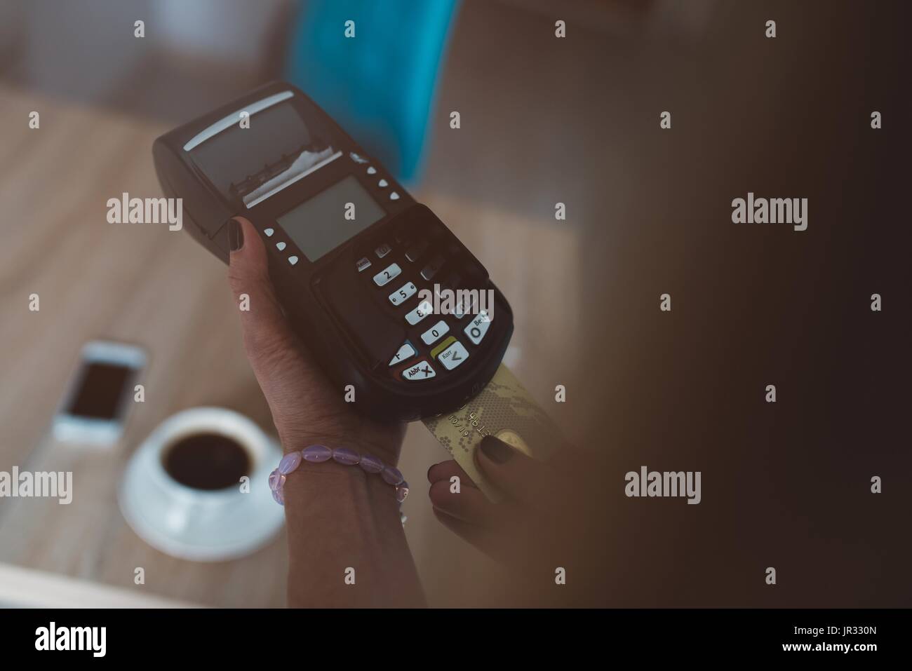 Woman pays plastic card hi-res stock photography and images - Alamy