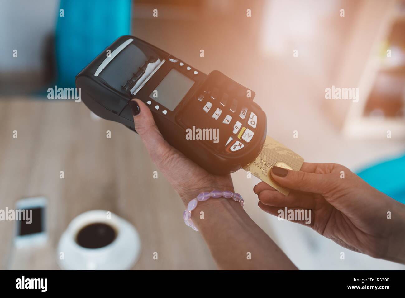 Woman pays plastic card hi-res stock photography and images - Alamy