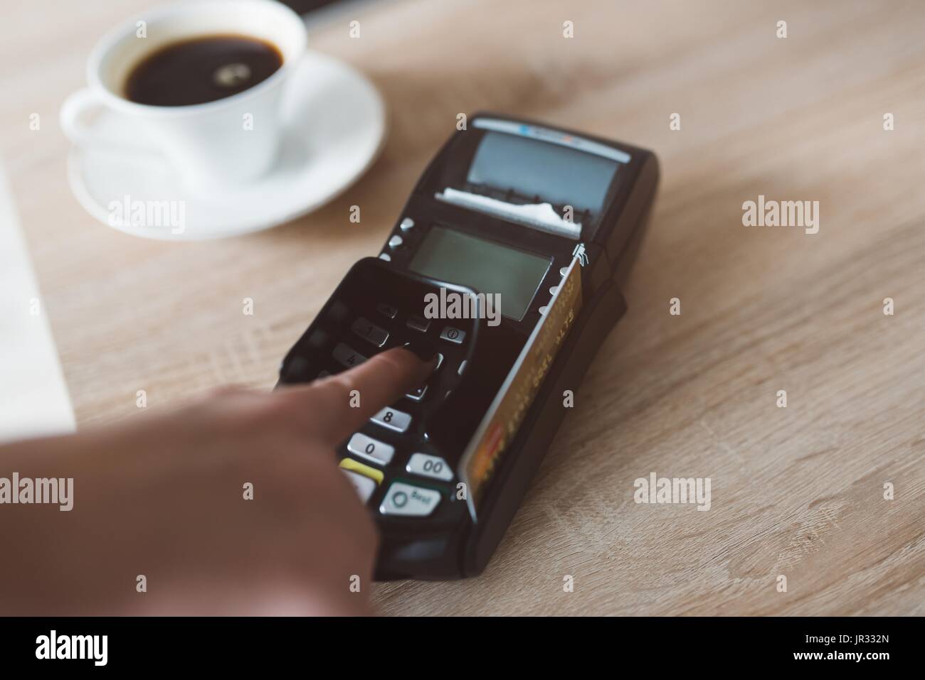 Consument entering pin code on card terminal during payment Stock Photo ...