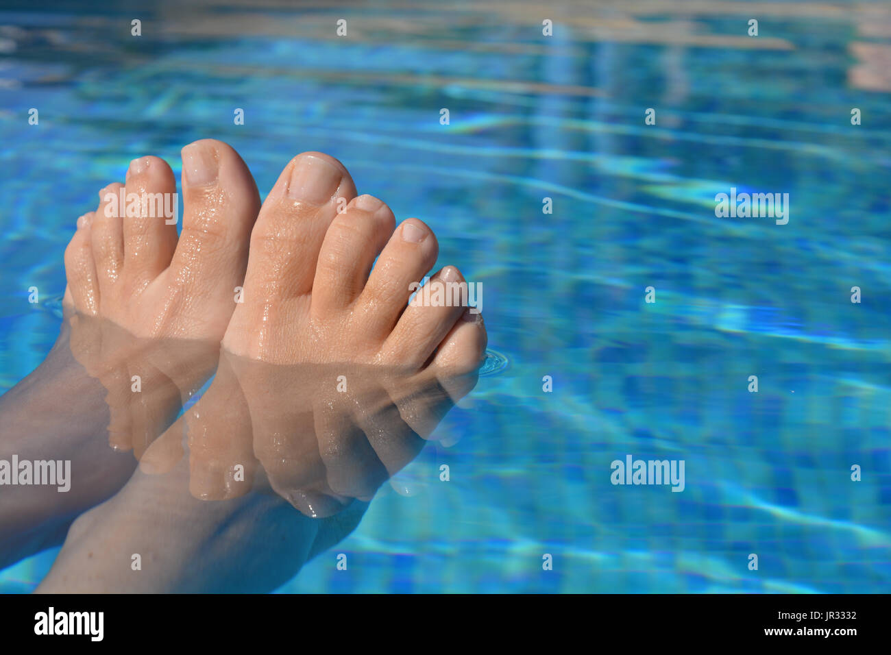 Woman floating in swimming pool, close up of feet Stock Photo - Alamy