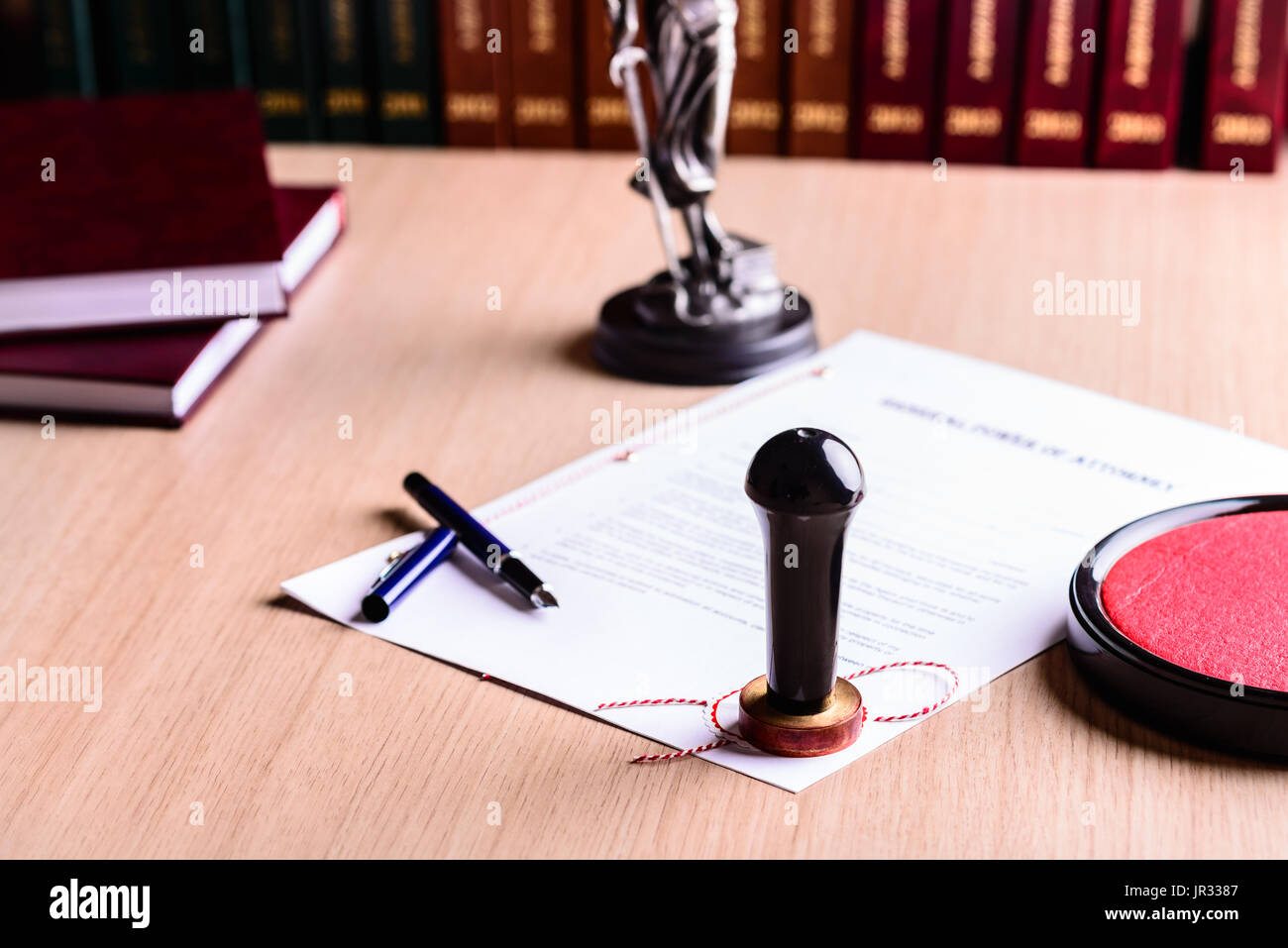 Stamp of the notary on signed power of attorney. Pen and Themis with ...