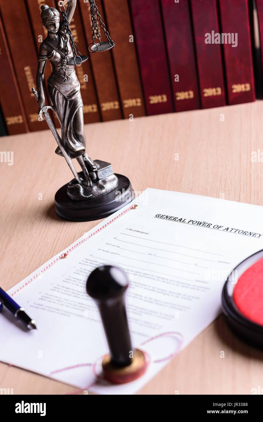 Notary public stamp on signed power of attorney. Pen and Themis with ...