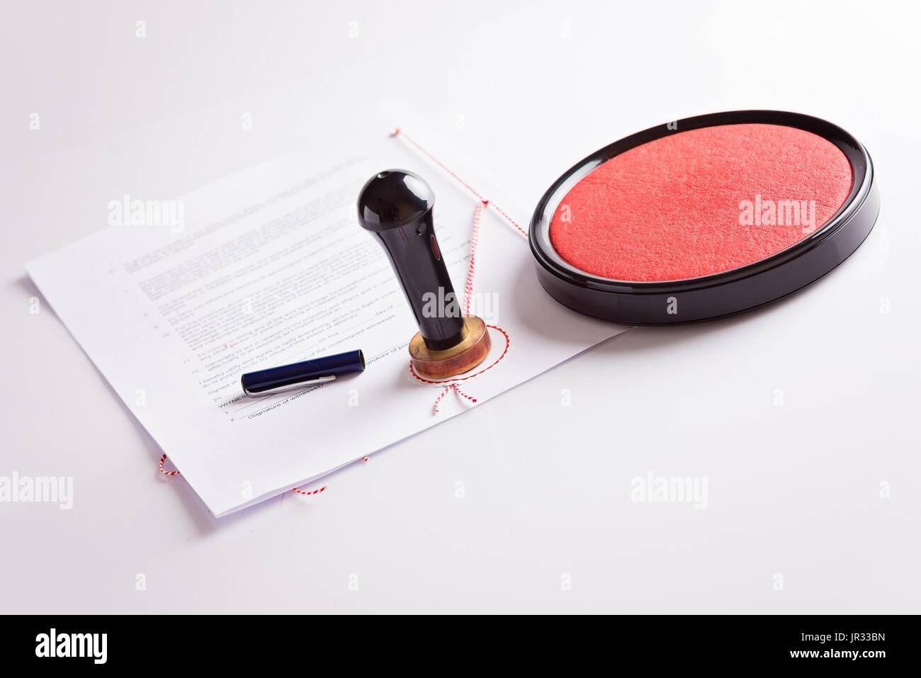 The document signed by a notary public with his stamp on a white ...