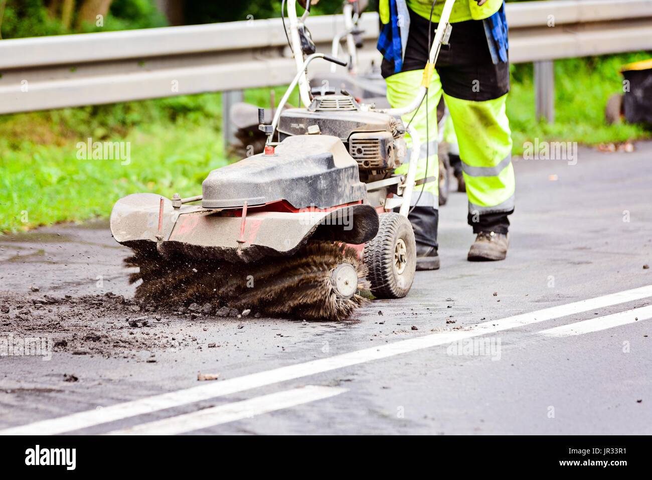 Worker removes with machine the upper layer of the tarmac Stock Photo ...