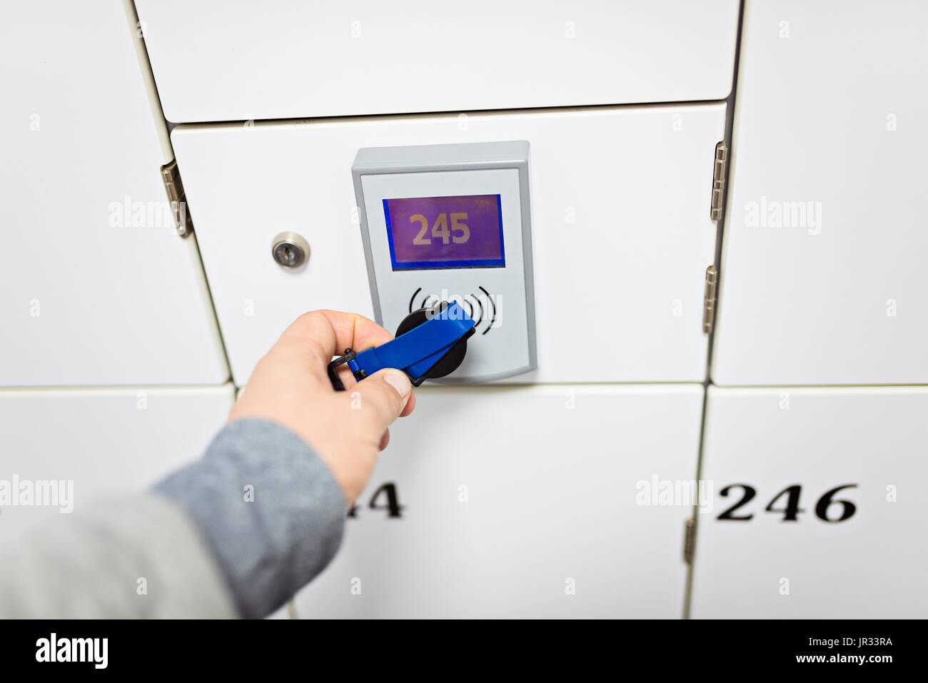 Closeup on hand opening change room locker with watch shape electronic ...