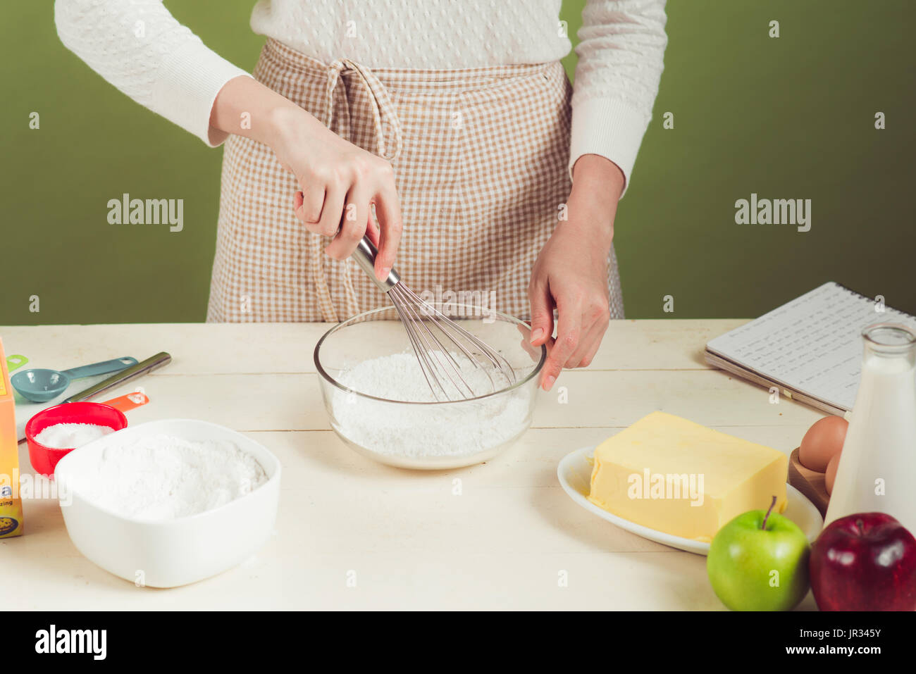 House wife wearing apron making. Steps of making cooking apple cake ...