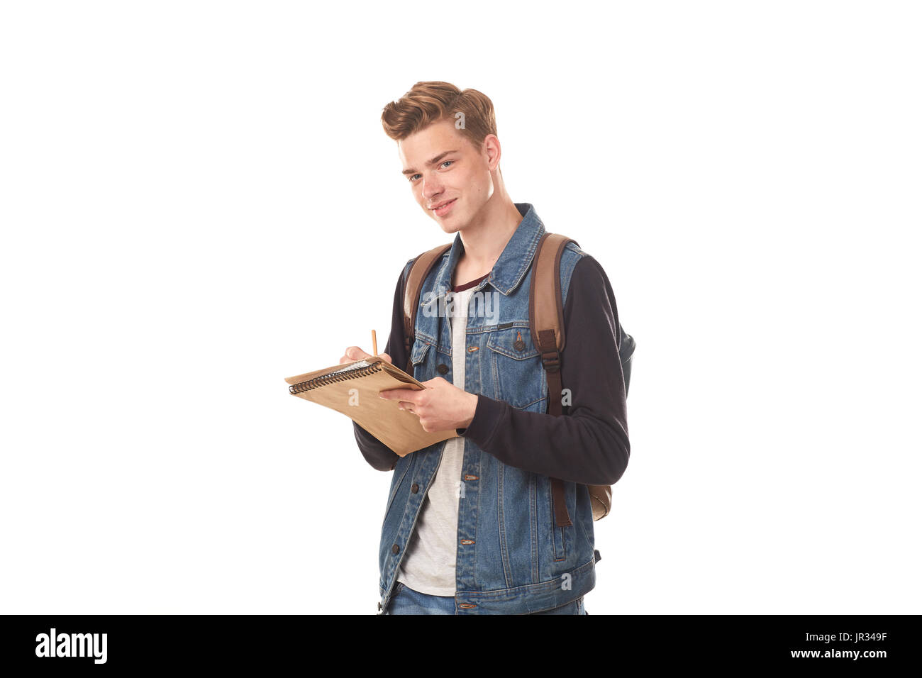 Schoolboy writing in notepad Stock Photo - Alamy