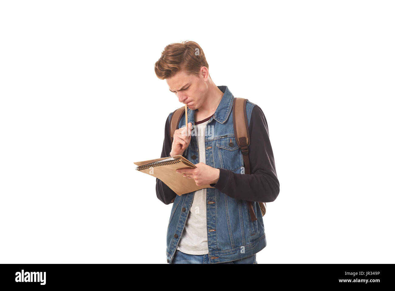 Schoolboy writing in notepad Stock Photo - Alamy
